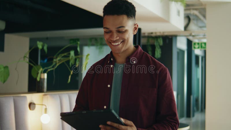 Smiling Young Businessman in Smart Casual Using Tablet PC while Walking ...