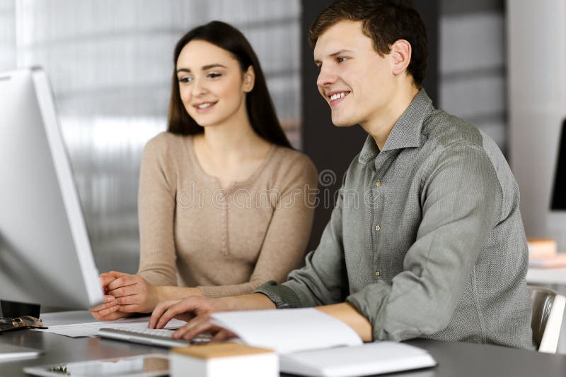 Smiling Young Businessmen and Programmers are Checking Some Data on ...