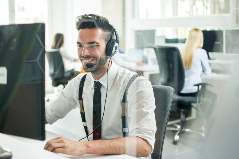Smiling Young Call Center Agent Speaking with Costumer. Stock Photo ...