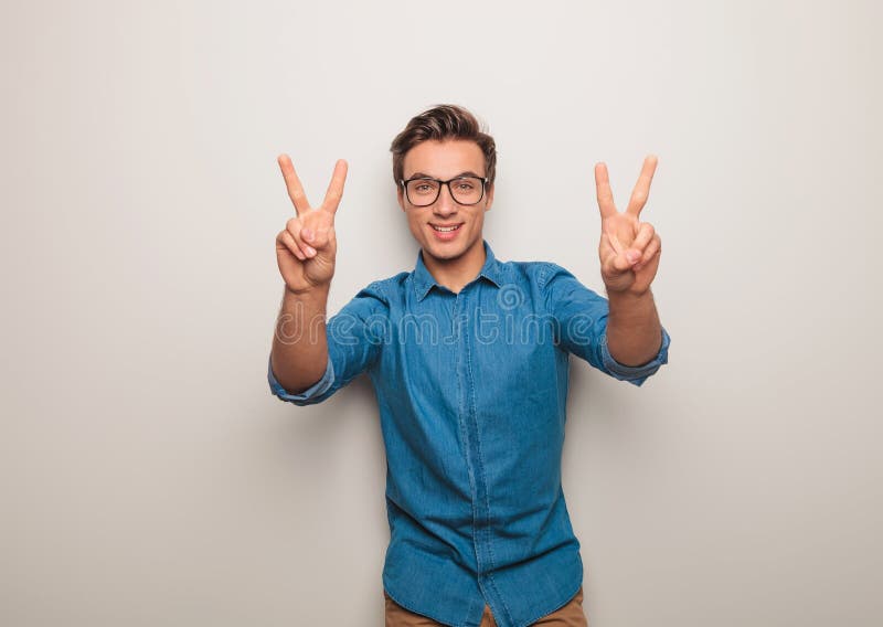 Smiling Young Casual Man Making Victory Sign Stock Photo - Image of ...