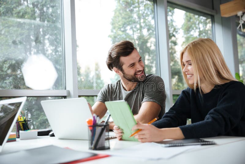 Smiling Young Colleagues Sitting in Office Coworking Stock Photo ...