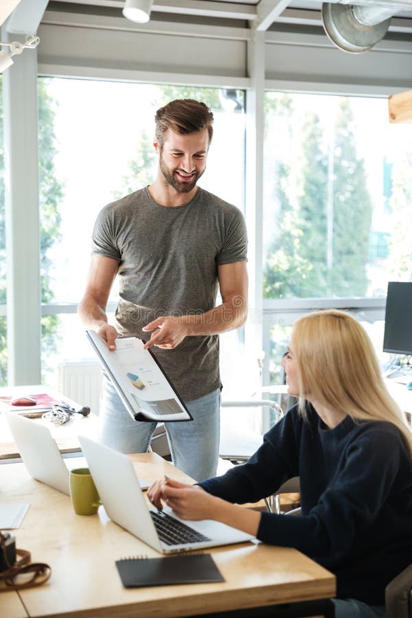 Smiling Young Colleagues Sitting in Office Coworking Stock Image ...