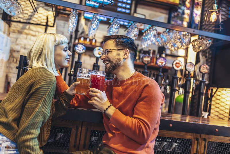 Young Couple at the Bar with Different Varieties of Craft Beers ...