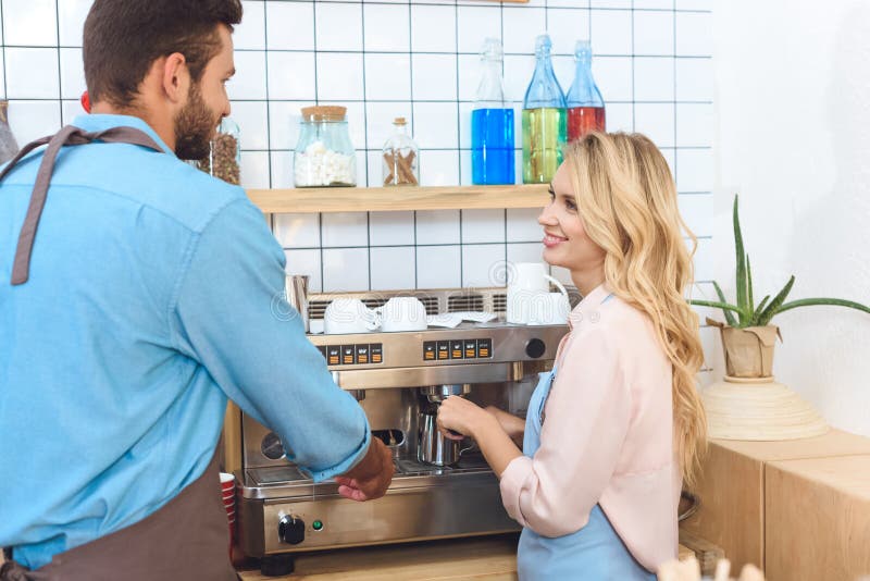 Smiling Young Couple of Cafe Workers Making Coffee Together and Using ...