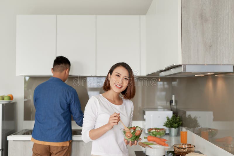 Smiling Young Couple Cooking Food in the Kitchen Stock Image - Image of ...