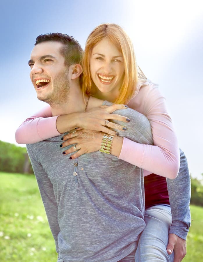 Smiling Young Couple Have a Fan Stock Photo - Image of fall, embracing ...