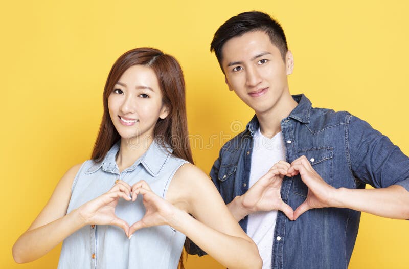 Young Couple with Heart Shape Hand Sign Stock Image - Image of ...