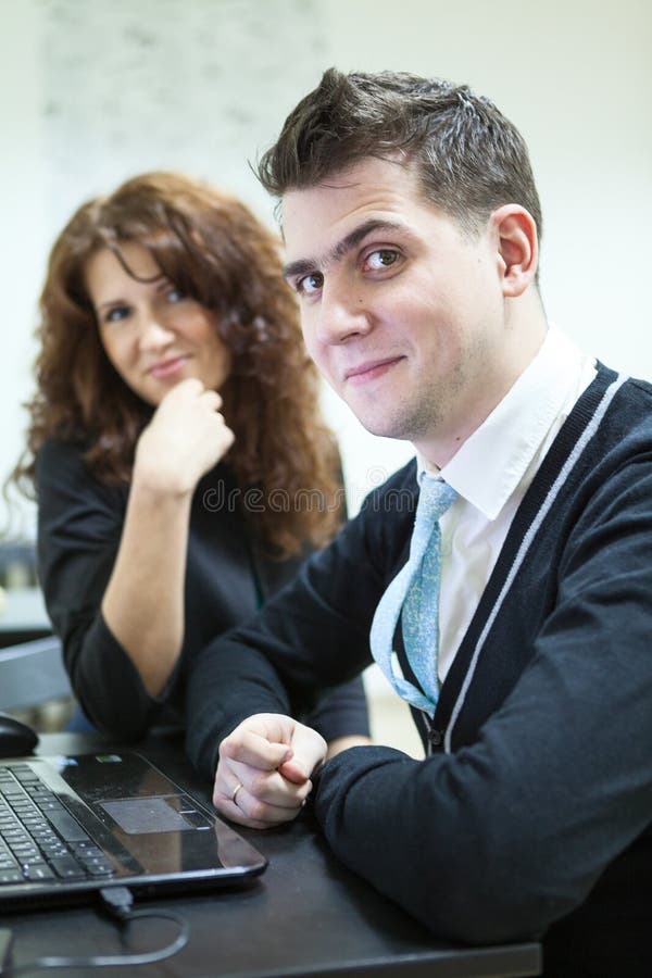 Smiling Young Couple with Laptop Looking at Camera Stock Photo - Image ...