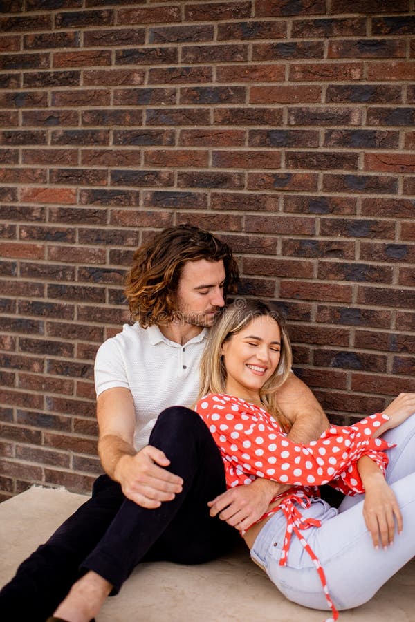 Smiling Young Couple in Love in Front of House Brick Wall Stock Image ...