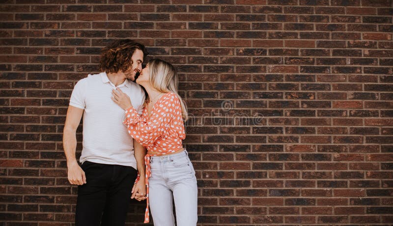Smiling Young Couple in Love in Front of House Brick Wall Stock Image ...