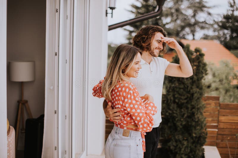 Smiling Young Couple in Love Looking in Front of House Brick Wall Stock ...