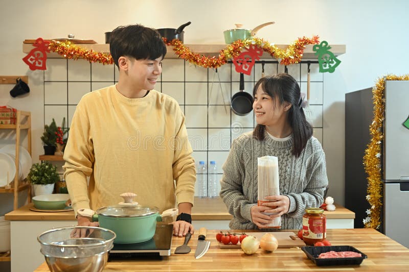 Smiling Young Couple Preparing for Their Christmas Dinner in Cozy ...