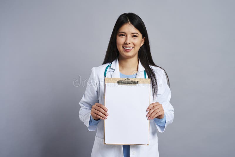 Smiling Doctor with Empty Piece of Paper Stock Photo - Image of apron ...