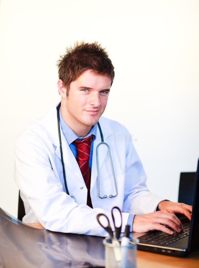 Smiling Young Doctor Working on a Computer Stock Photo - Image of ...
