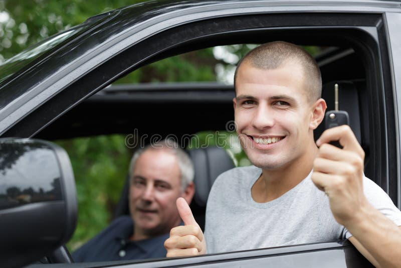 Smiling Young Driver Holding Cars Key with Instructor Stock Image ...
