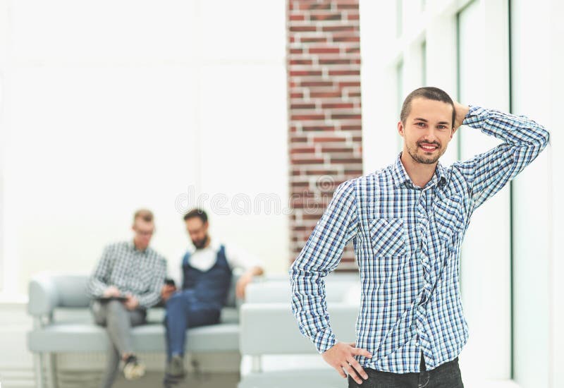 Smiling Young Employee Standing in the Office Stock Photo - Image of ...