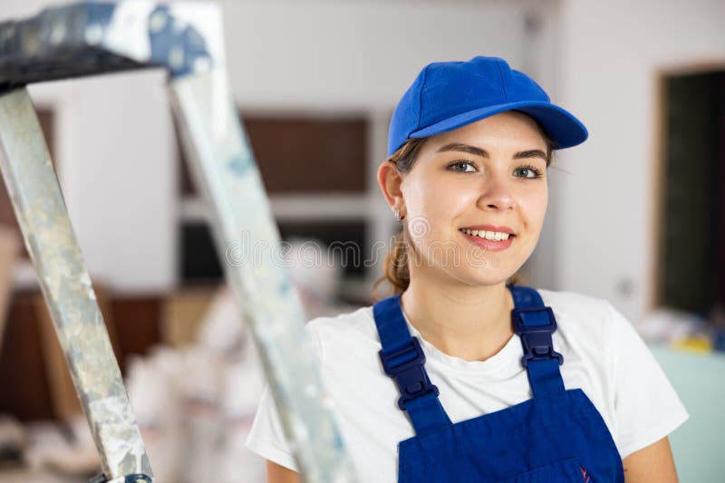 Smiling Young Female Builder in Blue Uniform at Construction Site Stock ...