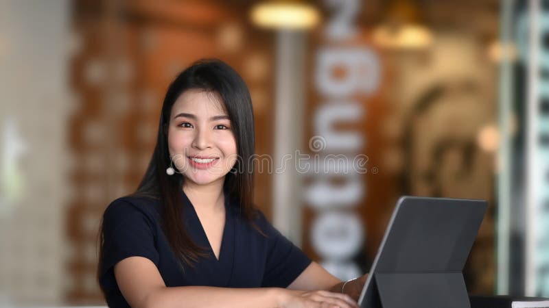 Young Female Entrepreneur Working on Tablet Computer and Smiling To ...