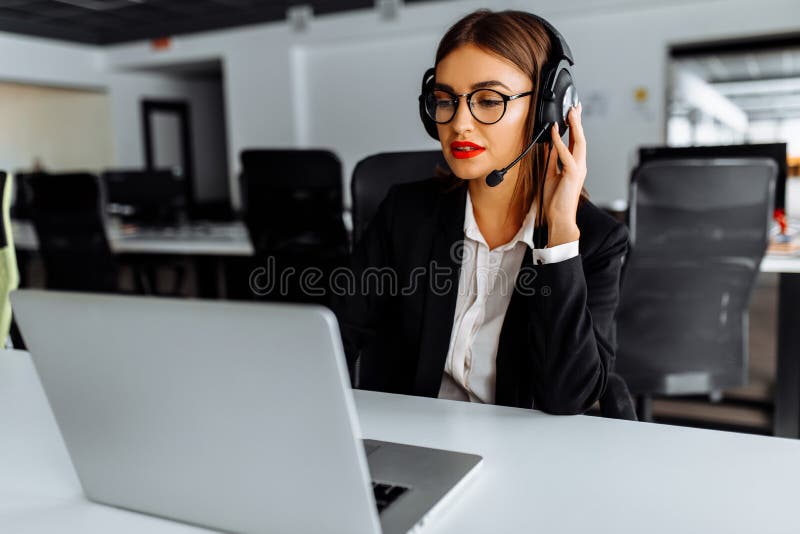 Smiling Young Female Operator in Headphones with Headset Working with ...