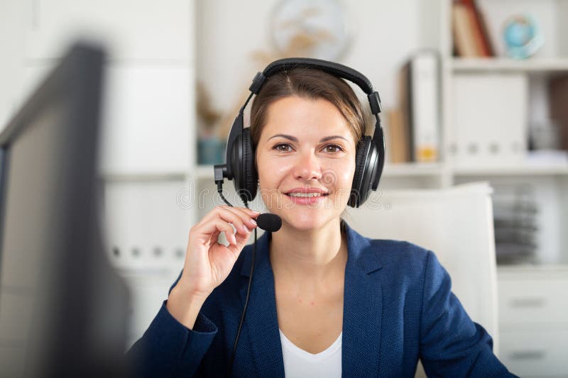 Smiling Young Female Operator Talking with Customer Using Headset at ...