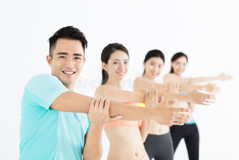 Smiling Young Fit Group Stretching in Gym Stock Photo - Image of hand ...