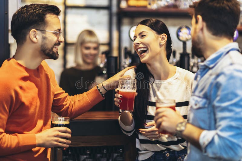 Young Friends Drinking Craft Beer in Pub Stock Image - Image of hipster, celebration: 264583623
