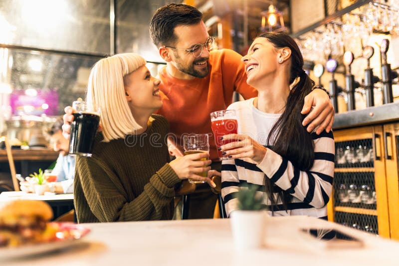Young Friends Drinking Craft Beer in Pub Stock Photo - Image of smiling ...