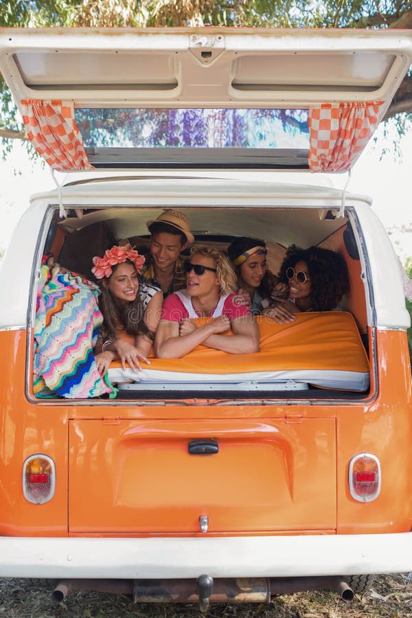 Smiling Young Friends Lying in Camper Van Stock Photo - Image of adult ...