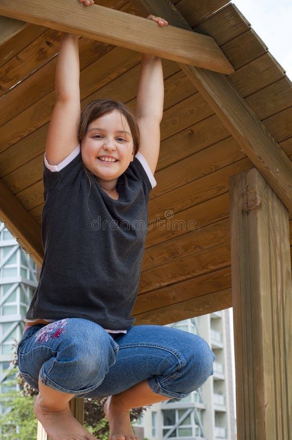 Smiling Young Girl Hanging on Wooden Structure Stock Image - Image of ...