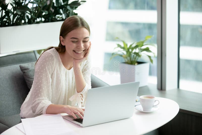 Smiling Girl Working at Laptop Sitting at Table Stock Image - Image of ...