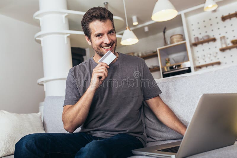 Young Handsome Man Using Credit Card and Laptop at Home Stock Photo ...