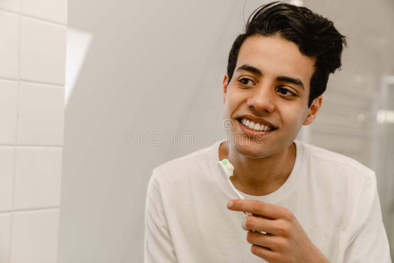 Smiling Young Hispanic Man Brushing Teeth Stock Image - Image of dental ...