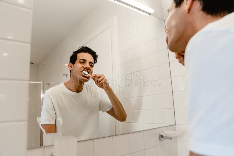 Smiling Young Hispanic Man Brushing Teeth Stock Image - Image of people ...
