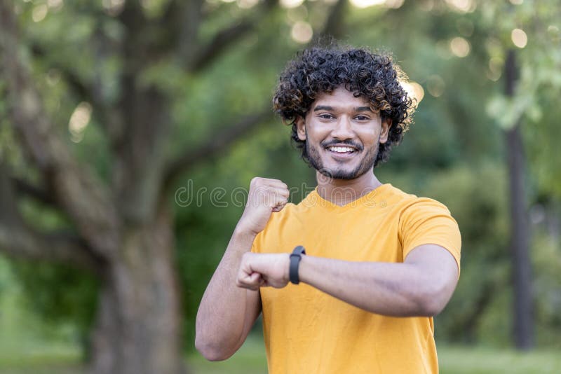 Active Young Indian Man Checking Fitness Tracker during Outdoor Workout ...
