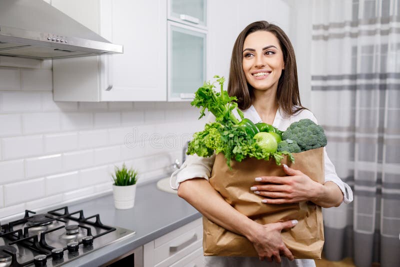 Smiling Young Lady Posing with Her Vegetable Purchases Stock Photo ...