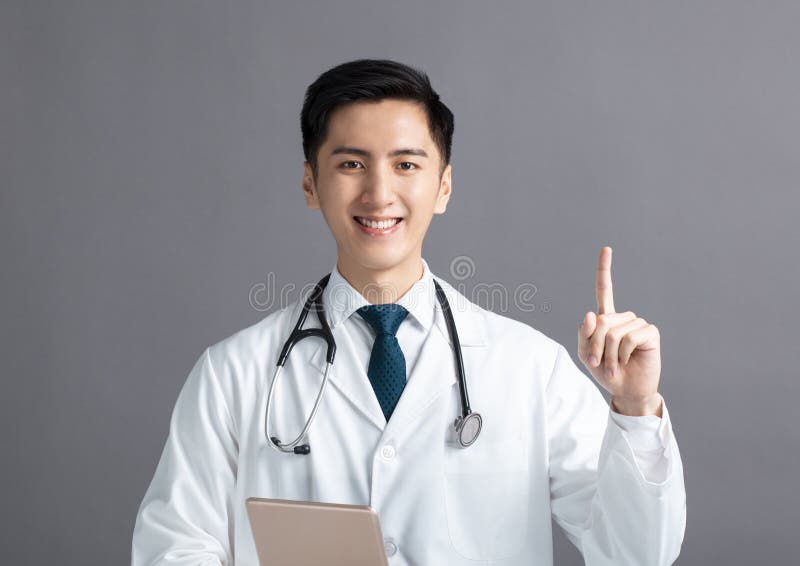 Smiling Young Male Doctor Hand Pointing Up Stock Photo - Image of ...