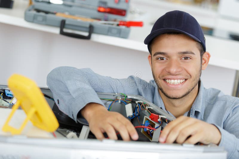Smiling young male worker stock photo. Image of workingman - 259683296