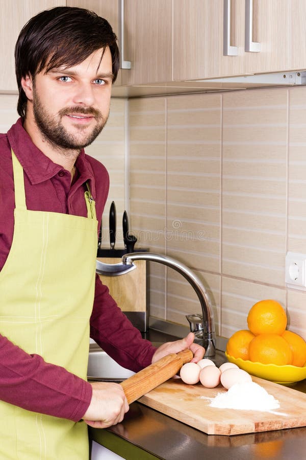 Smiling Young Man with Apron Holding a Rolling Pin Stock Image - Image ...