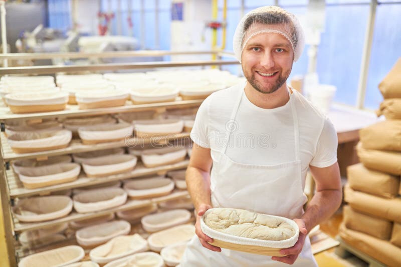 Smiling Young Man As a Baker Shows a Loaf of Bread Stock Photo - Image ...