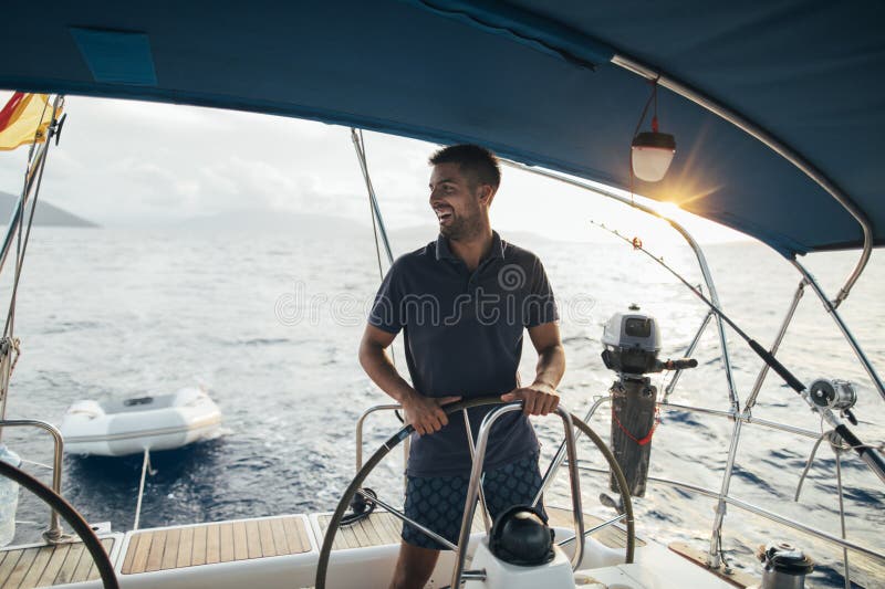 Smiling Young Man Helmsman Sailboat Stock Photos - Free & Royalty-Free ...