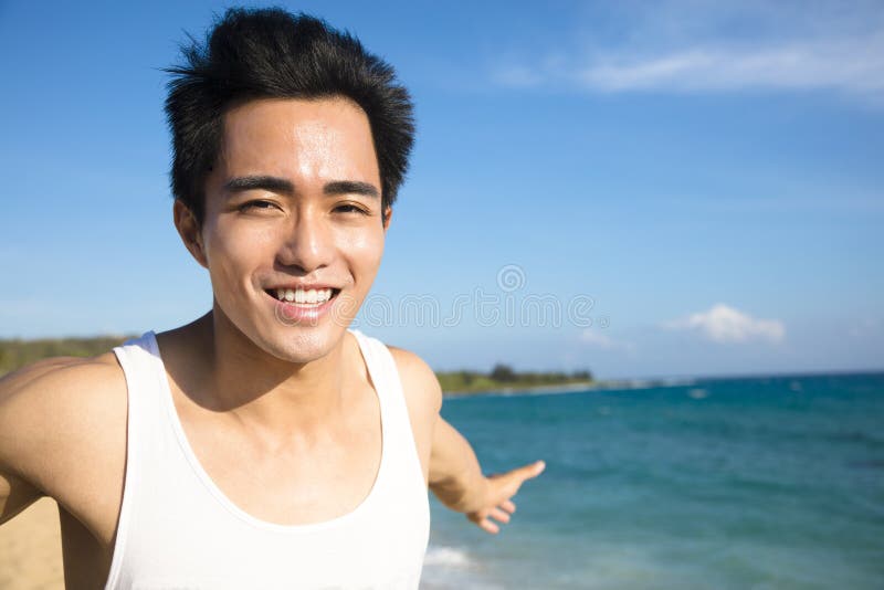 Smiling Young Man on the Beach Stock Photo - Image of japanese, nature ...