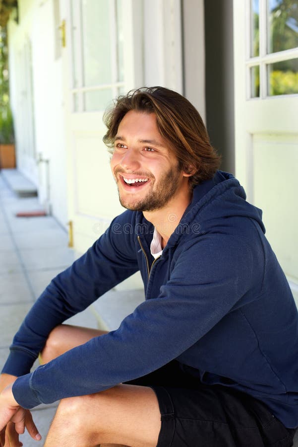 Smiling Young Man with Beard Sitting on Patio in Summer Stock Photo ... Smiling Young Man with Beard Sitting on Patio in Summer Stock Photo ...