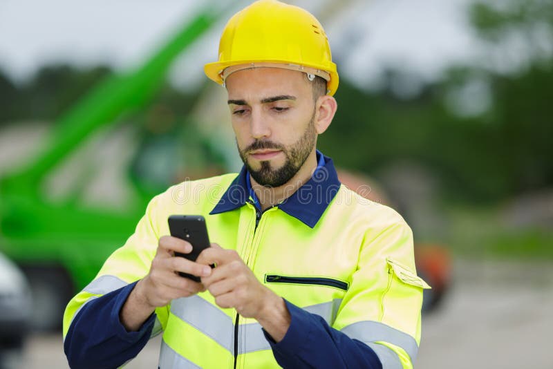 Smiling Young Man Builder in Hard Hat Using Mobile Phone Stock Image ...