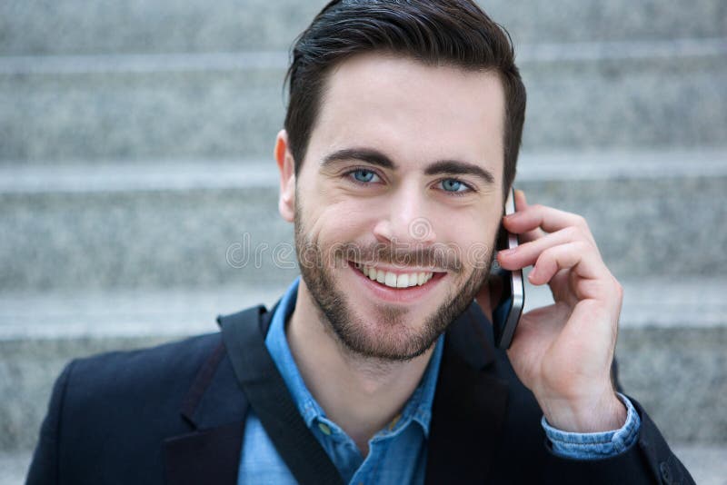 Smiling Young Man Calling by Mobile Phone Stock Image - Image of ...