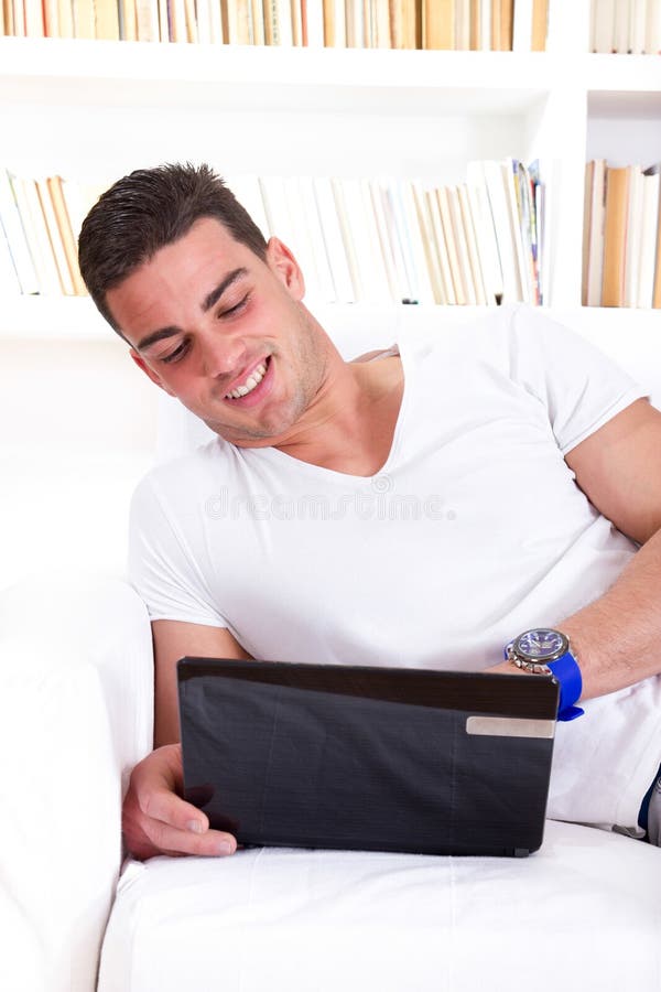 Smiling Young Man Chatting on Laptop Computer at Home Stock Photo ...