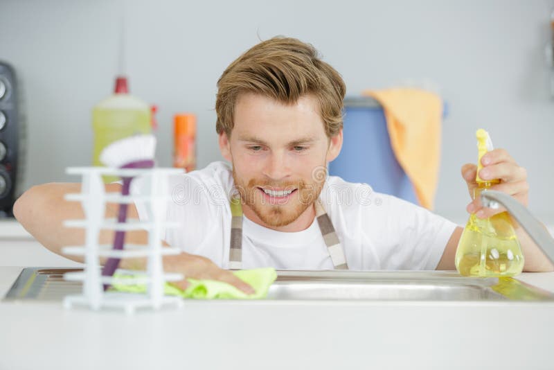 Smiling young man cleaning stock image. Image of chores - 150201153