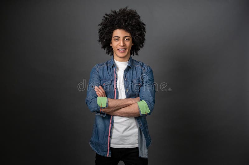Curly-haired Young Man Feeling Good and Smiling Stock Photo - Image of ...