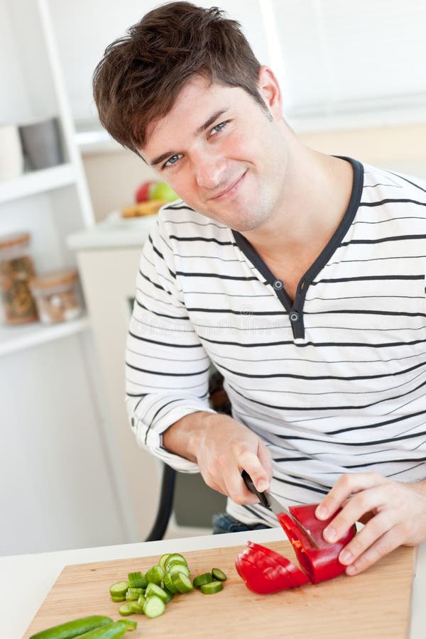 Smiling Young Man Cutting Vegetables Stock Image - Image of paprika ...
