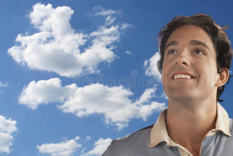 Smiling Young Man Daydreaming Against Cloudy Sky Stock Photo - Image of ...