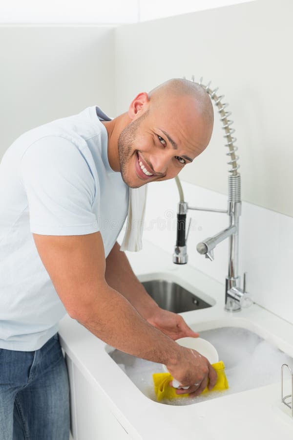 Smiling Young Man Doing the Dishes at Kitchen Sink Stock Image - Image ...